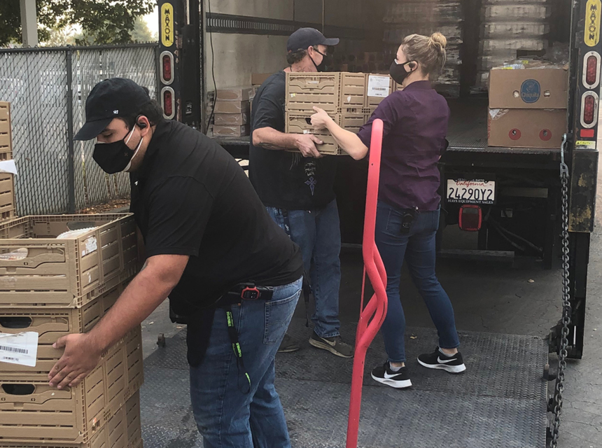 Image of team members loading food into a delivery truck