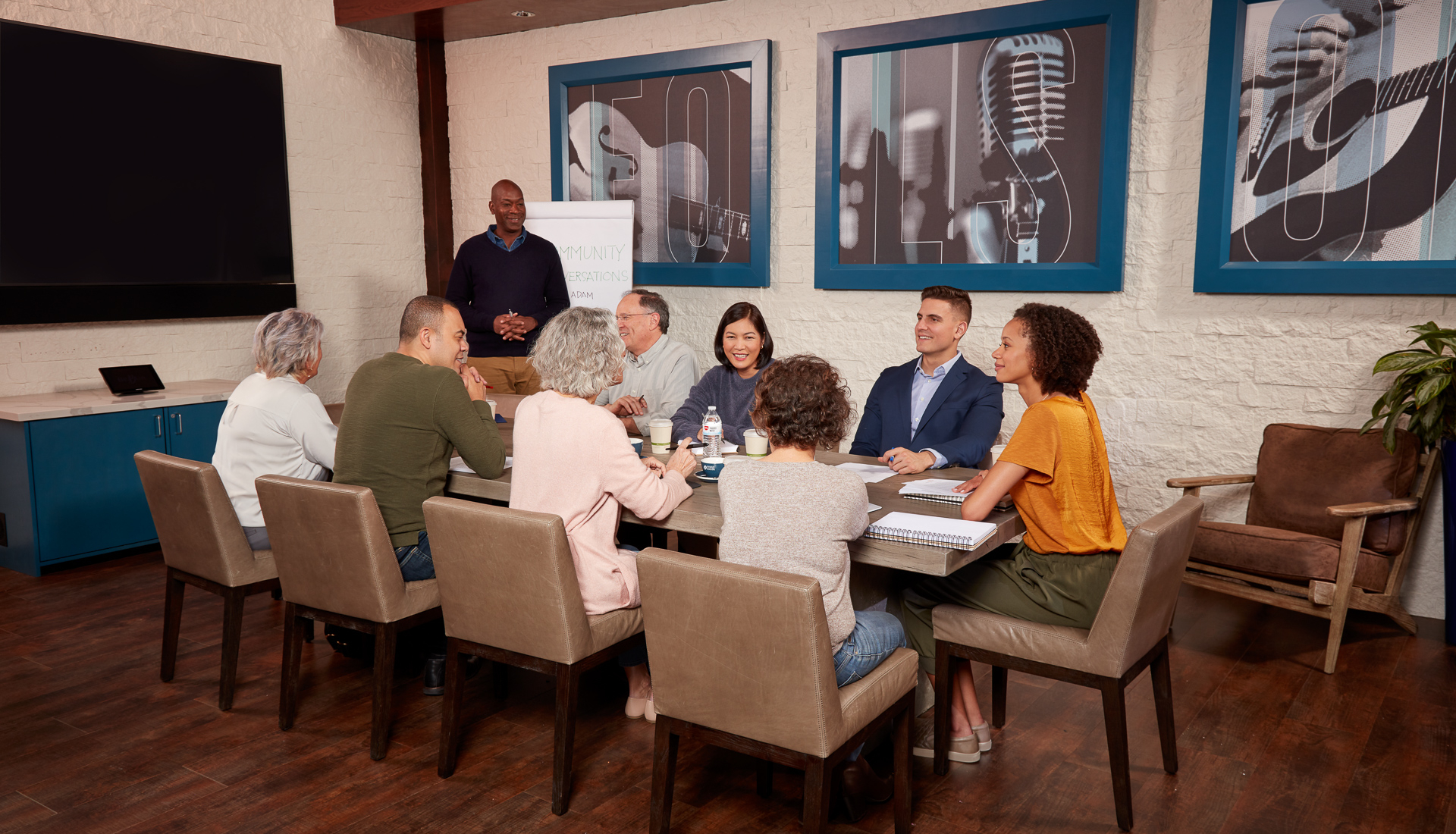 Image is of an Something Extra Gather room with people meeting